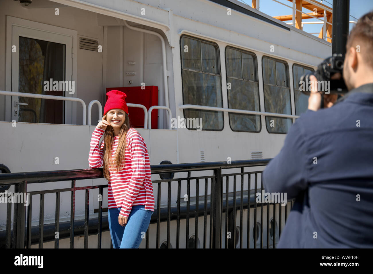 Photographer taking picture of beautiful woman on embankment Stock ...