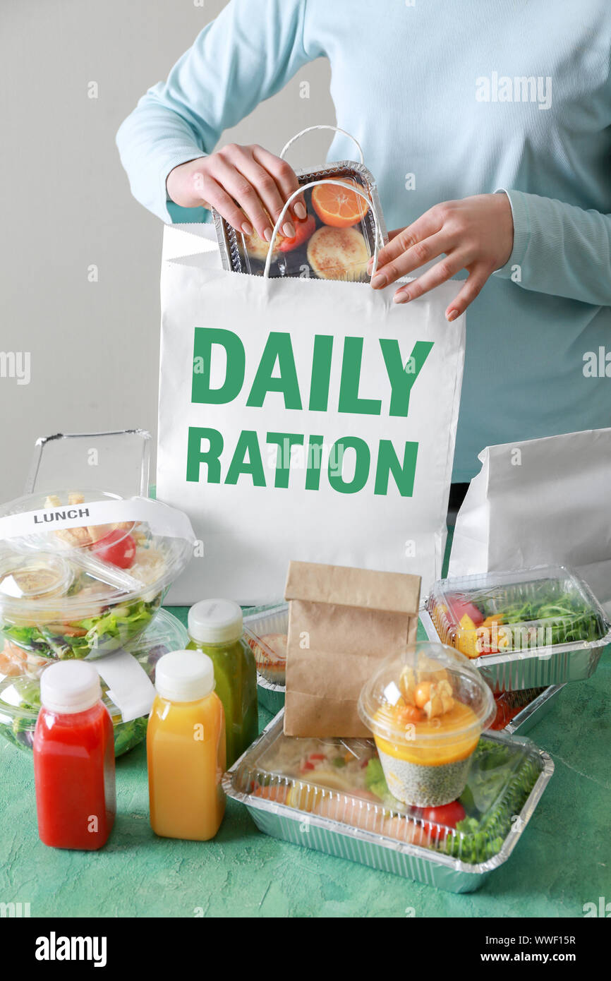 Worker of food delivery service packing order for customer Stock Photo ...