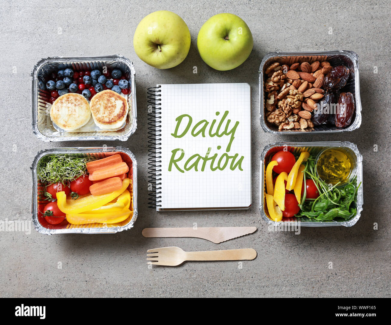 Containers with daily ration and notebook with text DAILY RATION on ...