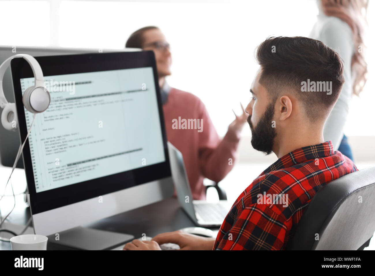 Male programmer working in office Stock Photo - Alamy