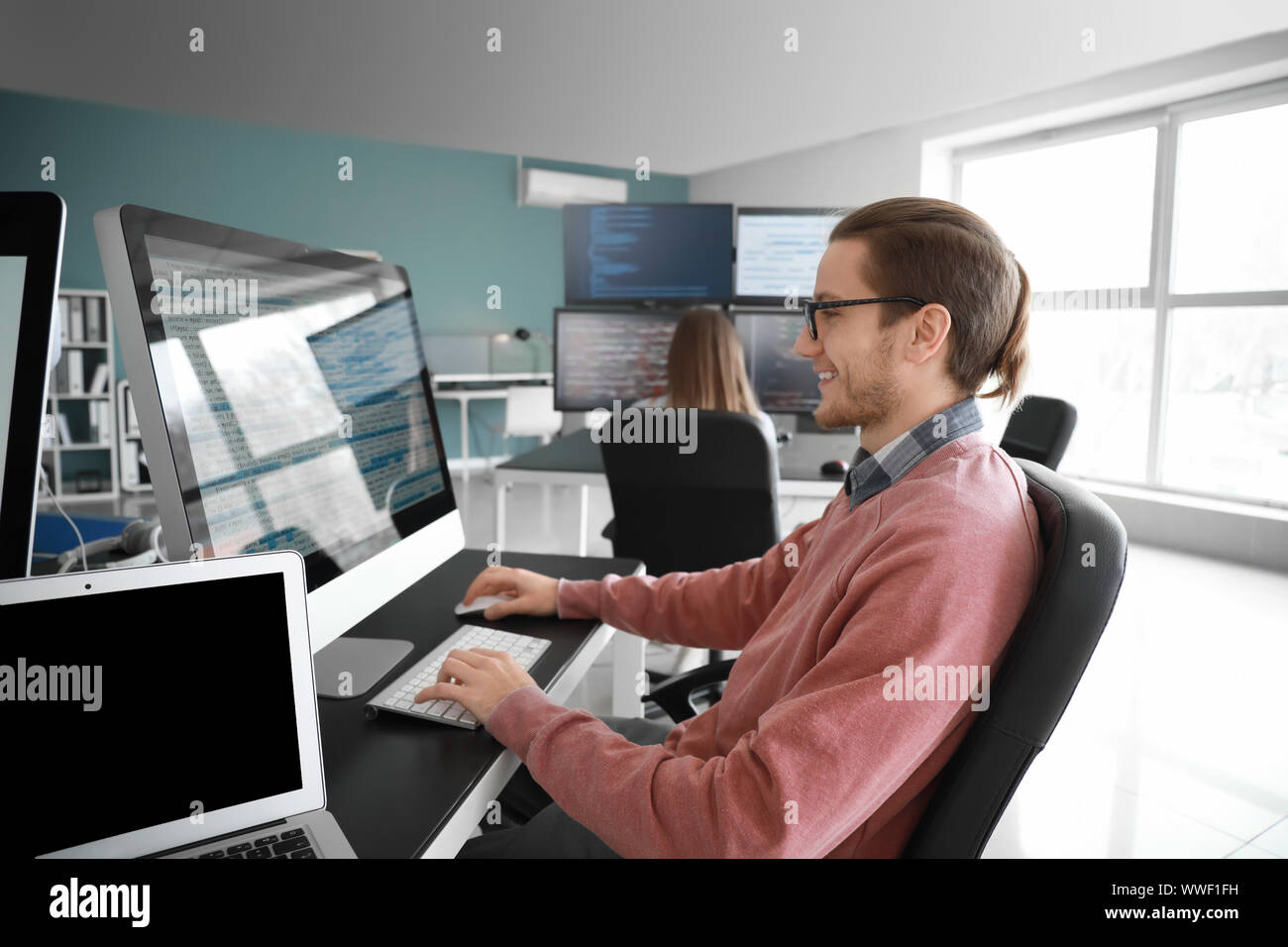 Male programmer working in office Stock Photo - Alamy