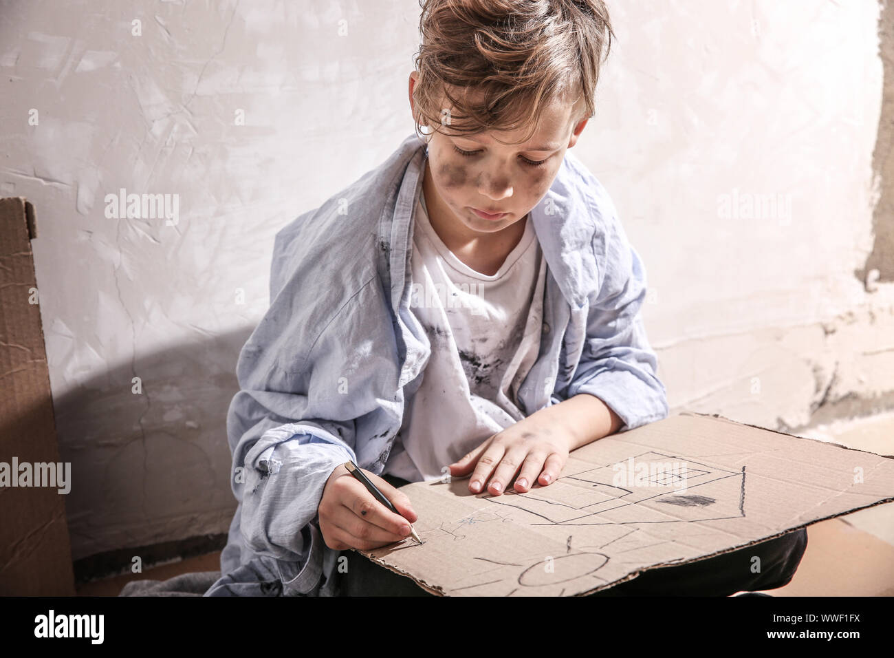 Homeless little boy dreaming about home Stock Photo - Alamy