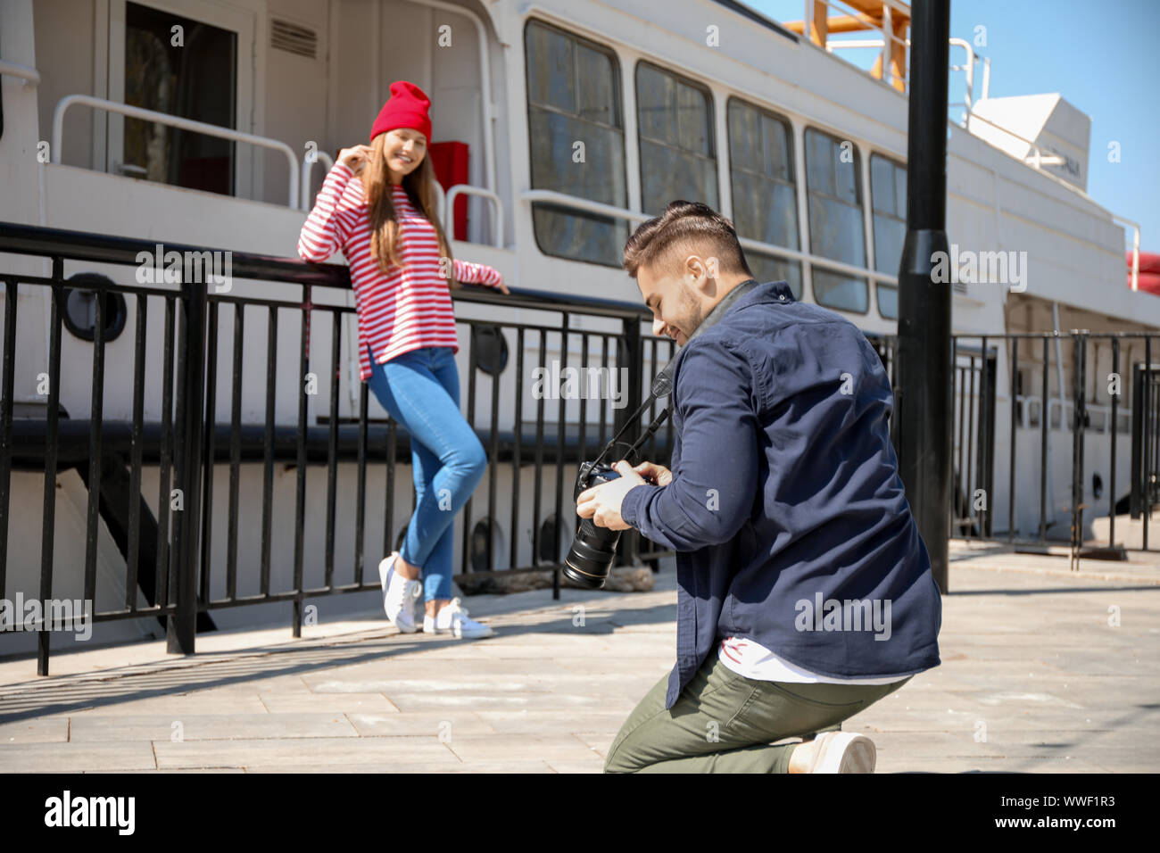 Photographer taking picture of beautiful woman on embankment Stock ...