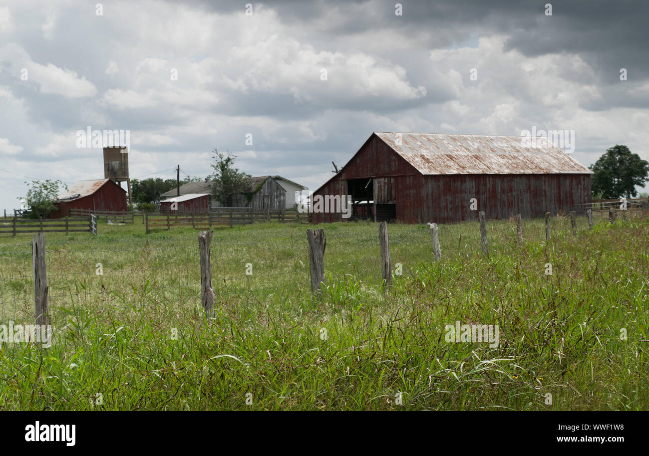 Classic All American Red Barn in South Texas Country With Wooden Fence ...
