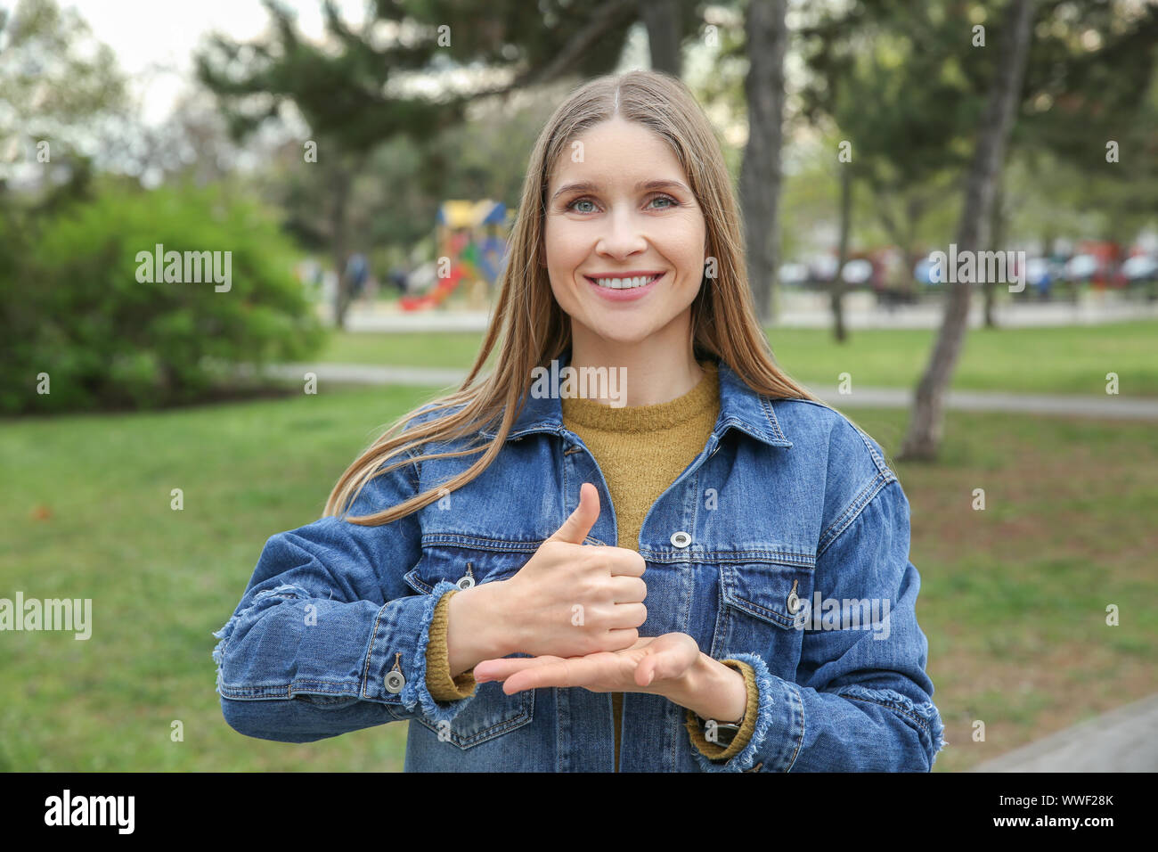 Young deaf mute woman using sign language outdoors Stock Photo - Alamy