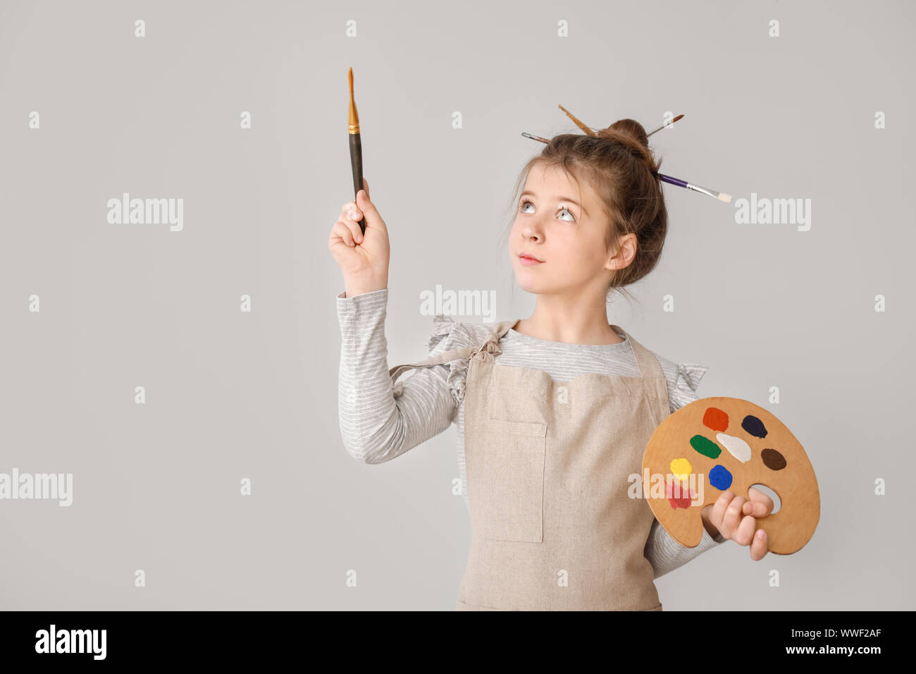 Cute little artist on light background Stock Photo - Alamy
