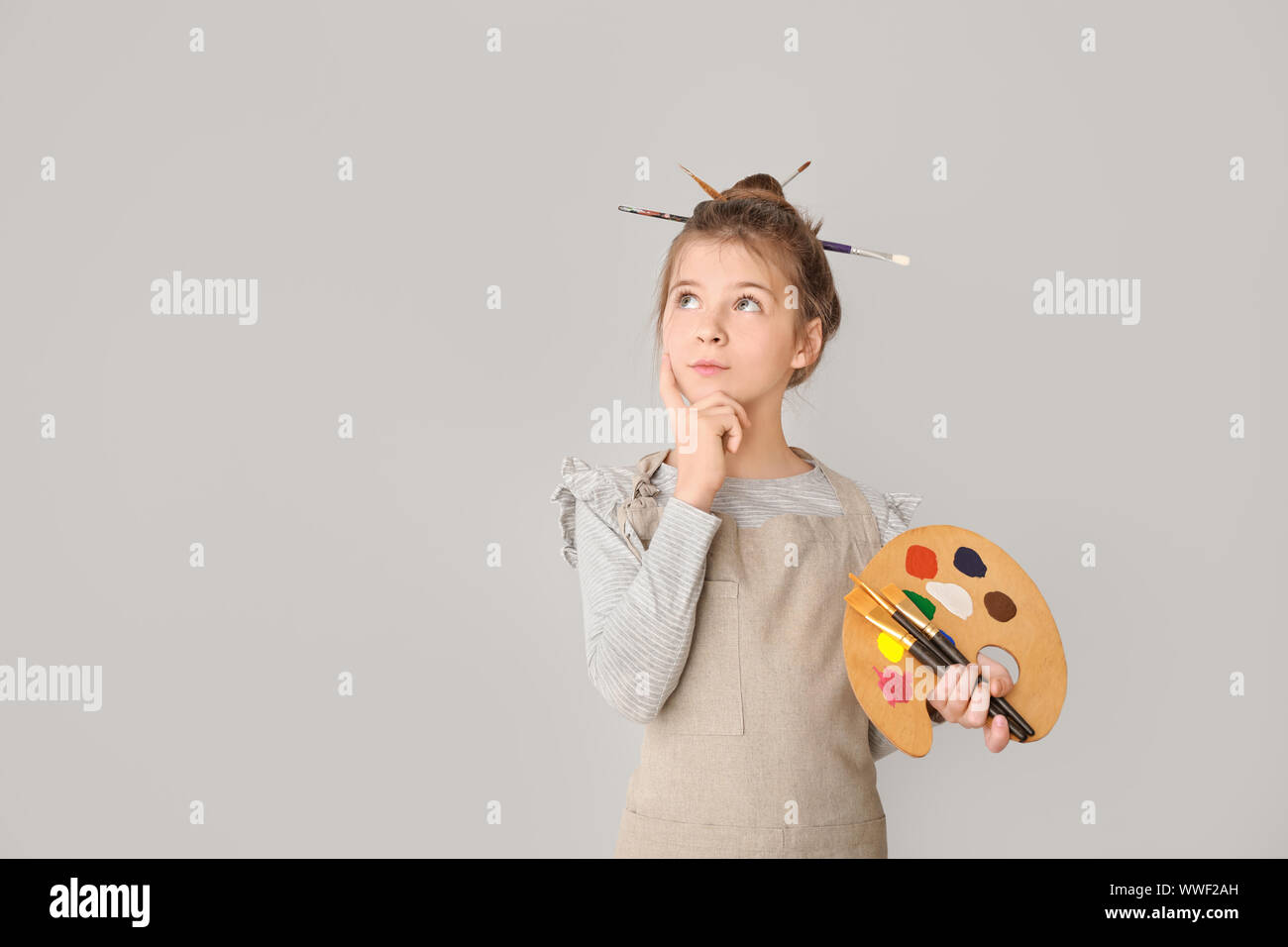 Cute little artist on light background Stock Photo - Alamy