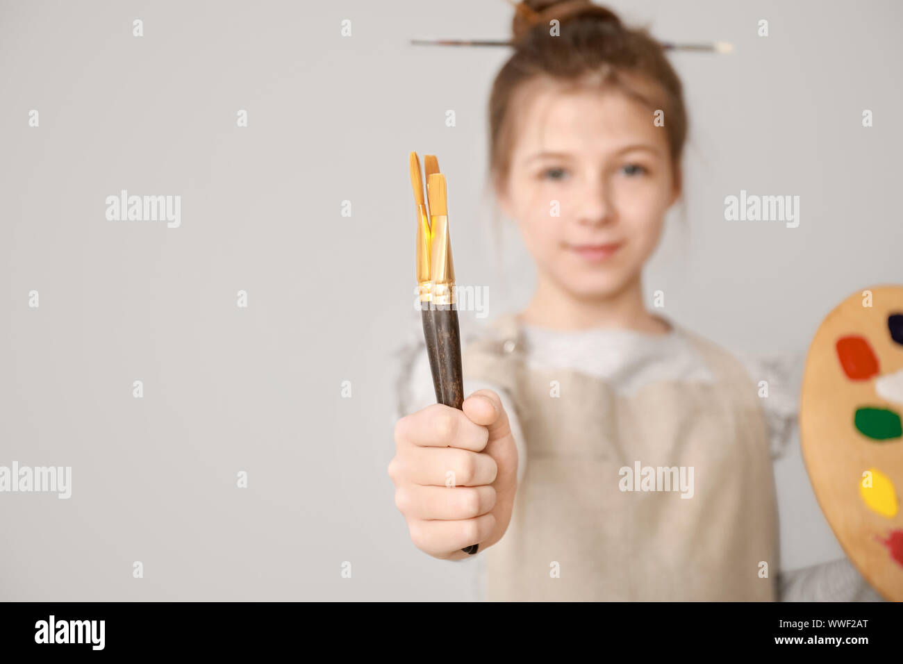 Cute little artist on light background Stock Photo - Alamy