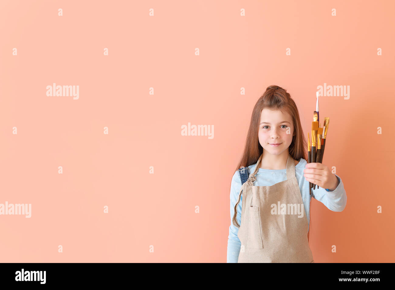 Cute little artist on color background Stock Photo - Alamy