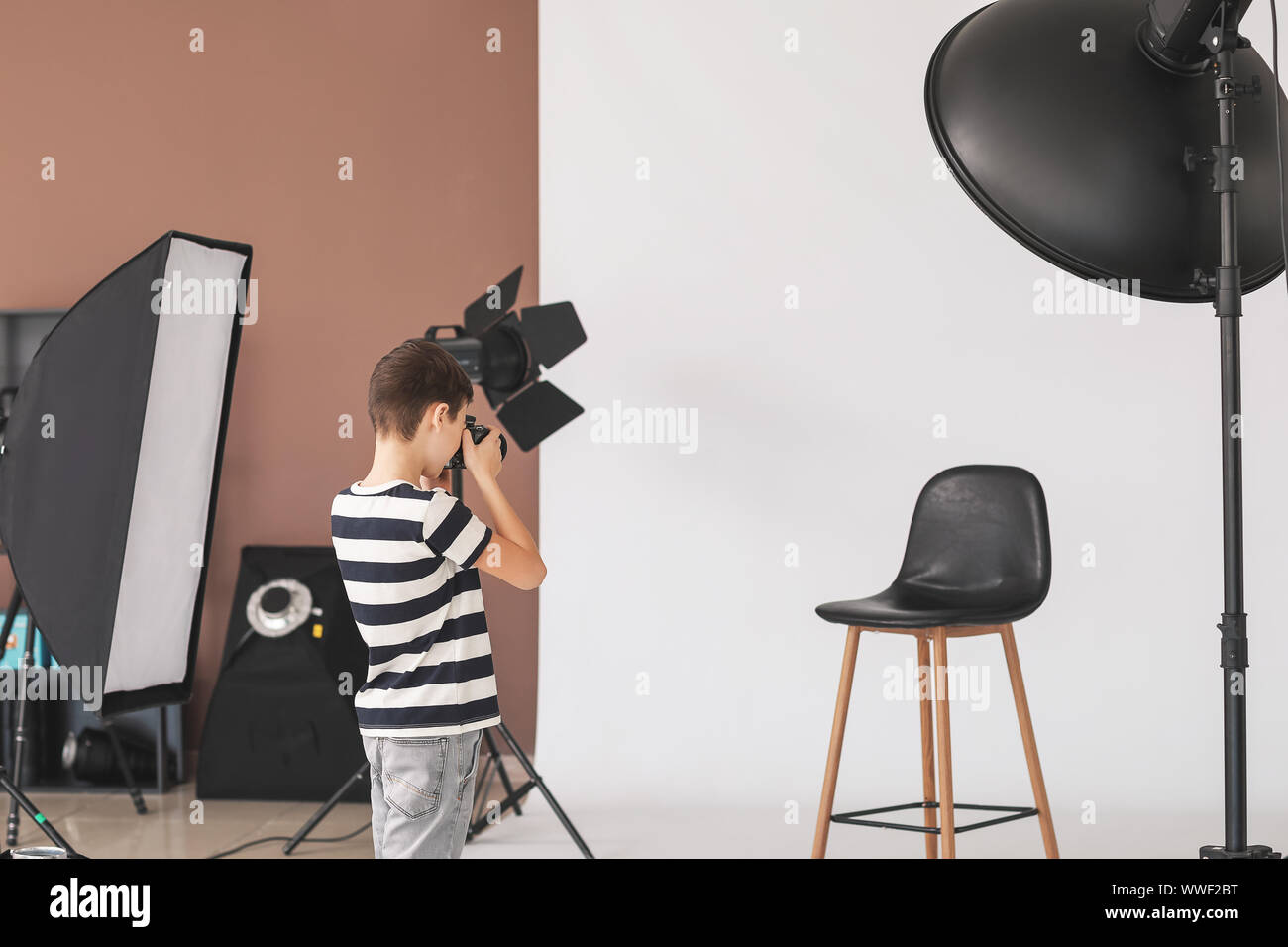 Cute little photographer in professional studio Stock Photo - Alamy