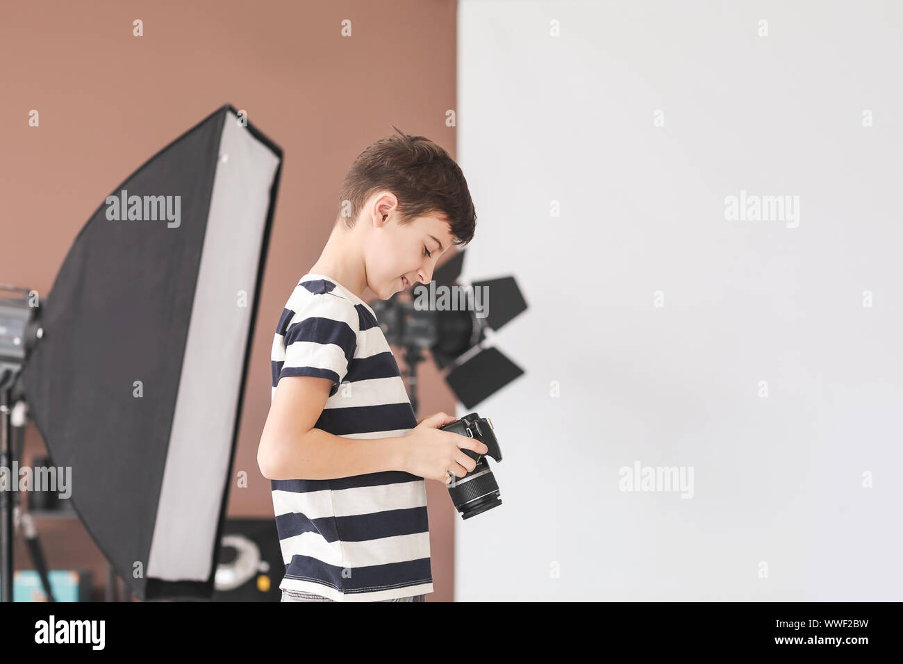 Cute little photographer in professional studio Stock Photo - Alamy