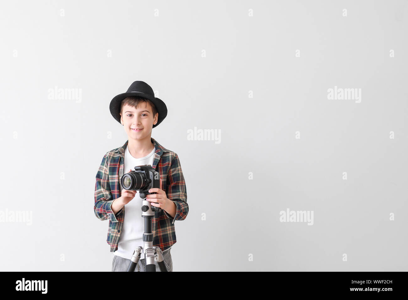 Cute little photographer on white background Stock Photo - Alamy