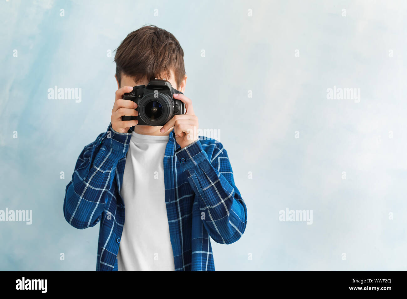 Cute little photographer on color background Stock Photo - Alamy