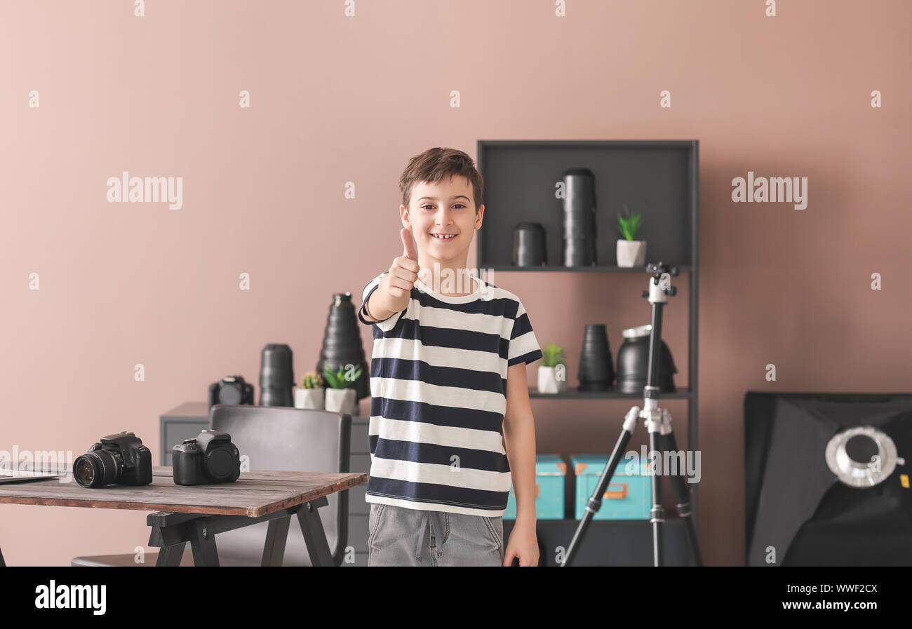 Cute little photographer in professional studio Stock Photo - Alamy