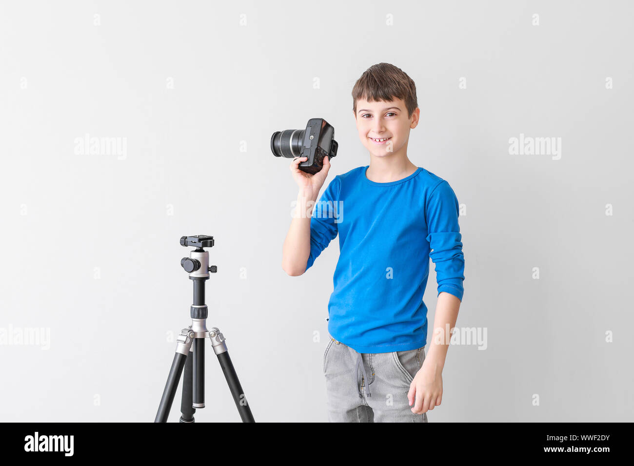 Cute little photographer on white background Stock Photo - Alamy
