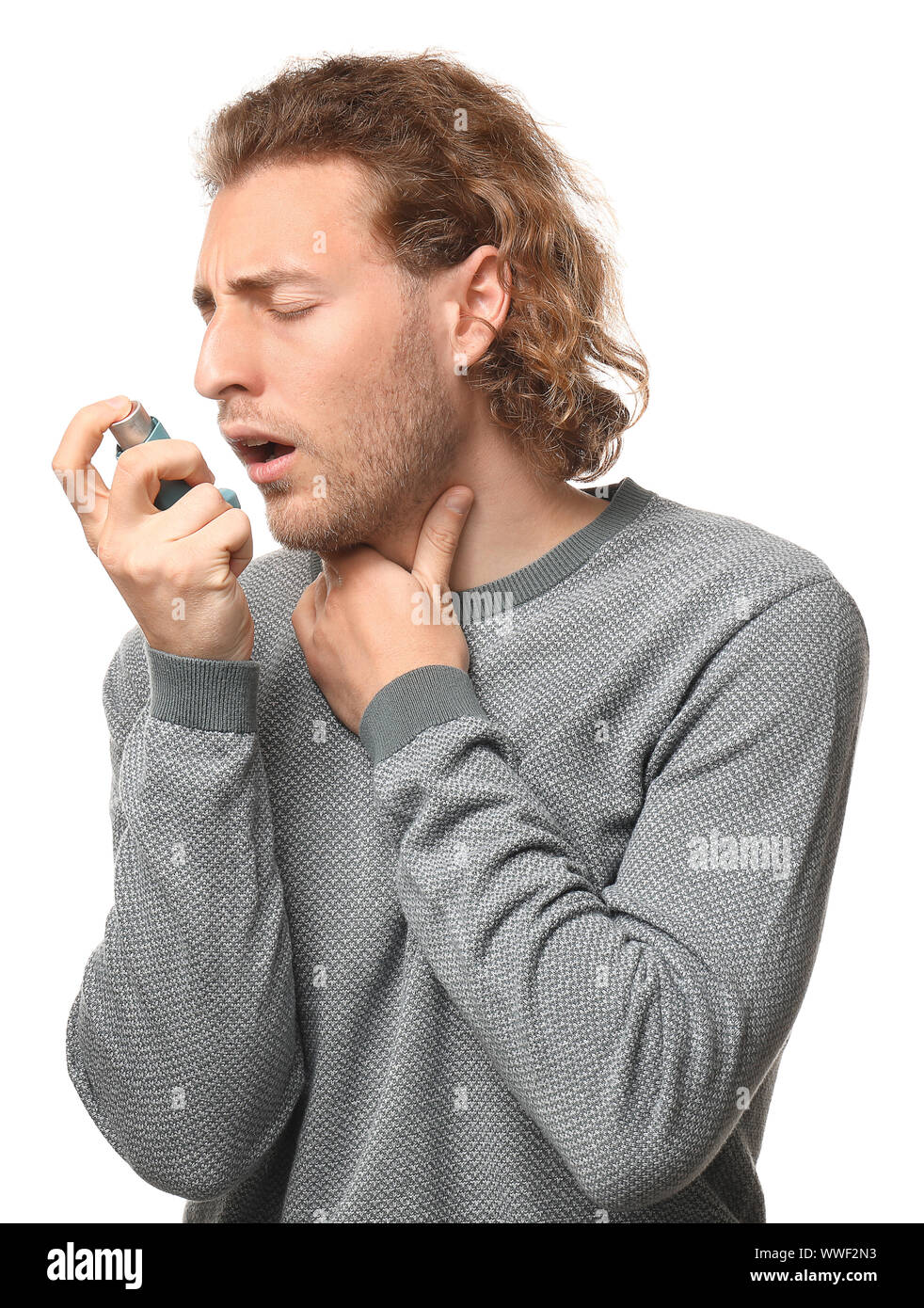 Young man with inhaler having asthma attack on white background Stock ...