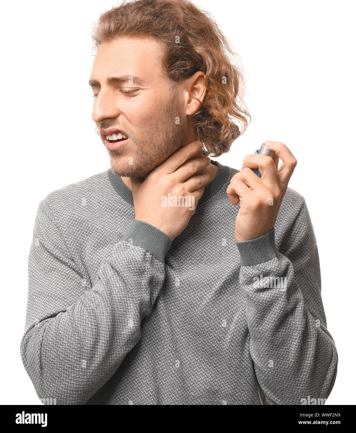 Young man with inhaler having asthma attack on white background Stock ...