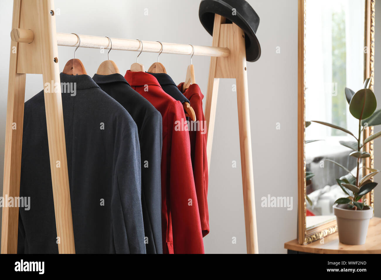 Rack with clothes in hall Stock Photo - Alamy