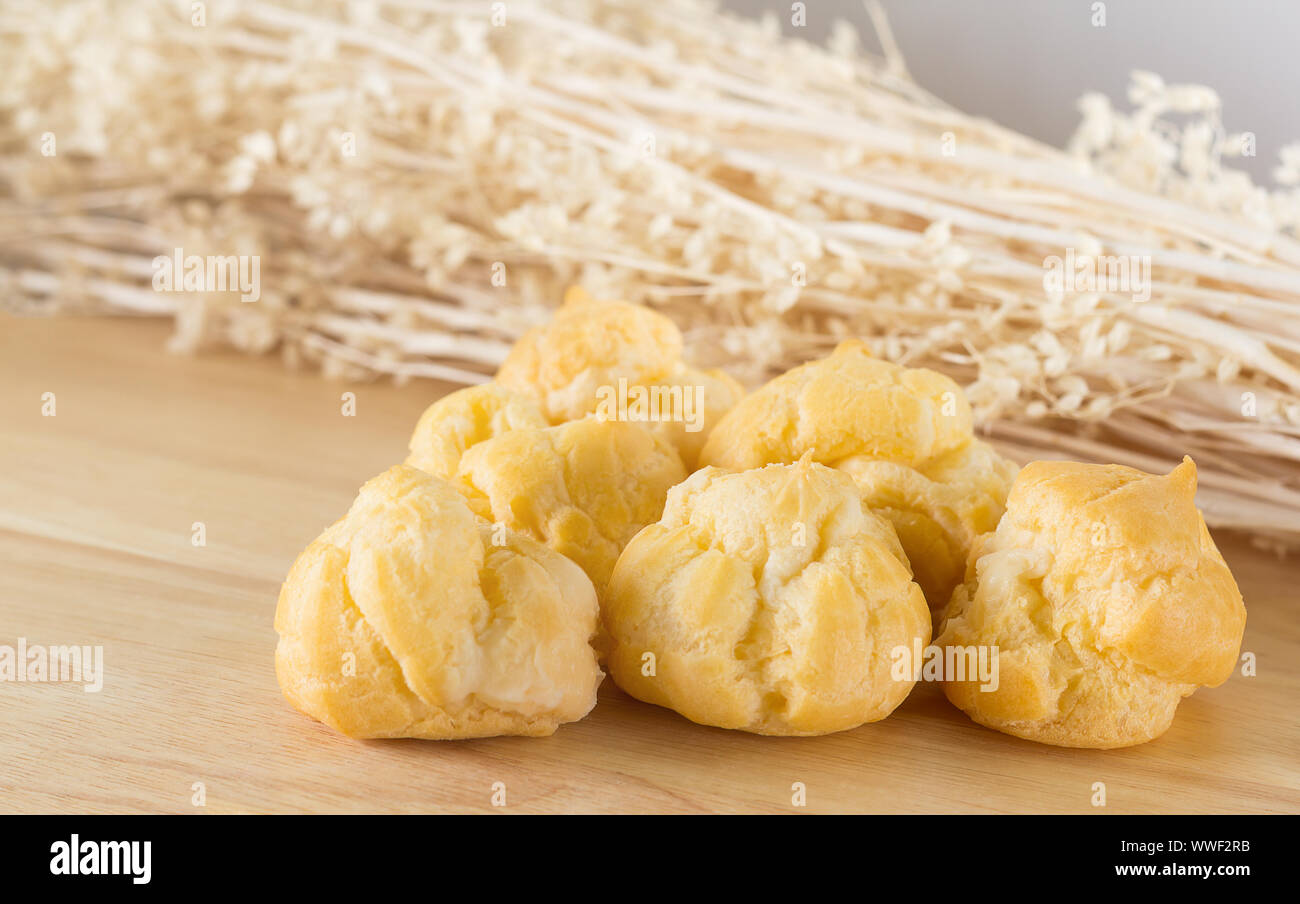 Homemade cream puff, choux, eclair on wood table Stock Photo - Alamy