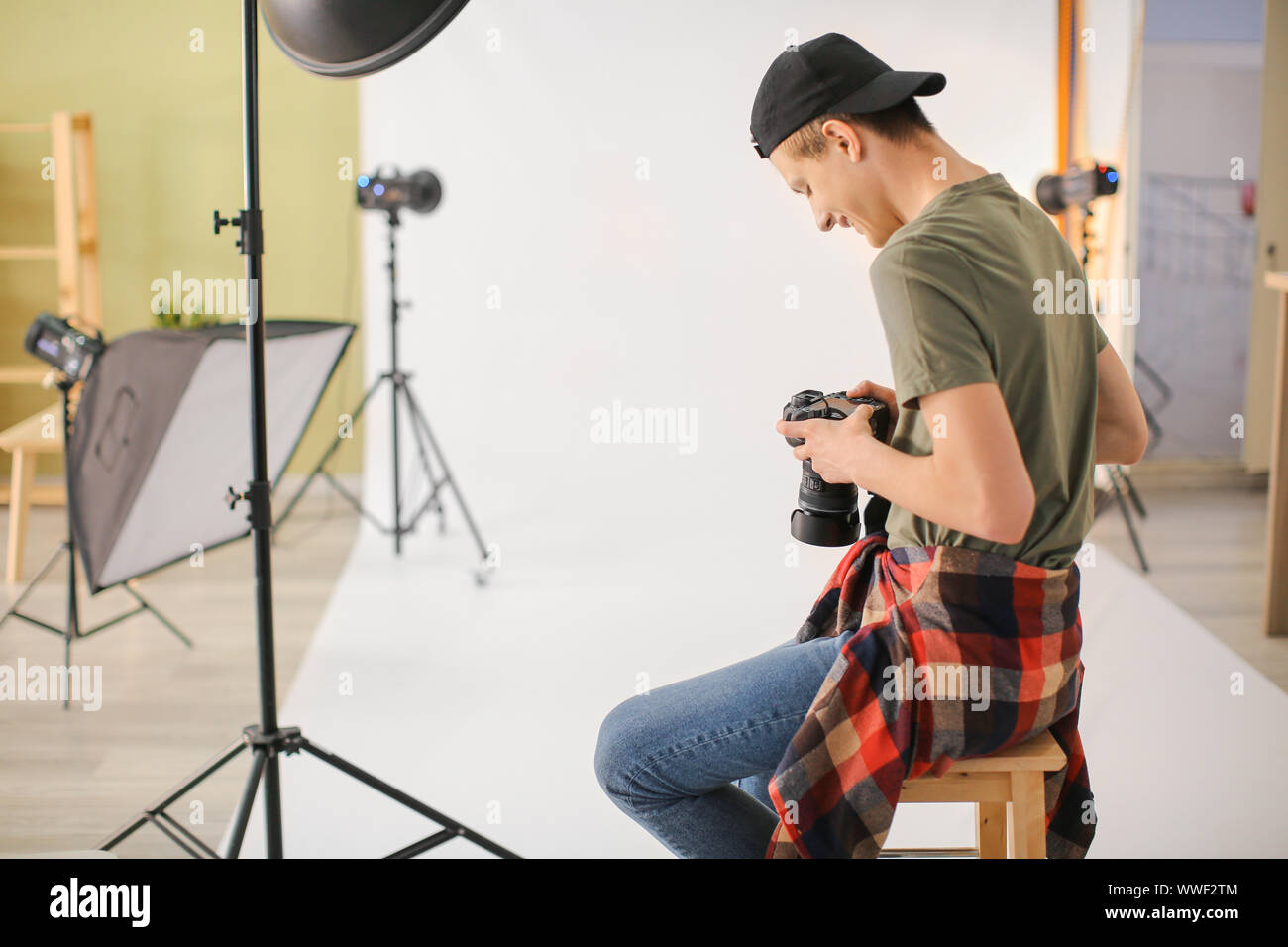 Teenage photographer in professional studio Stock Photo - Alamy