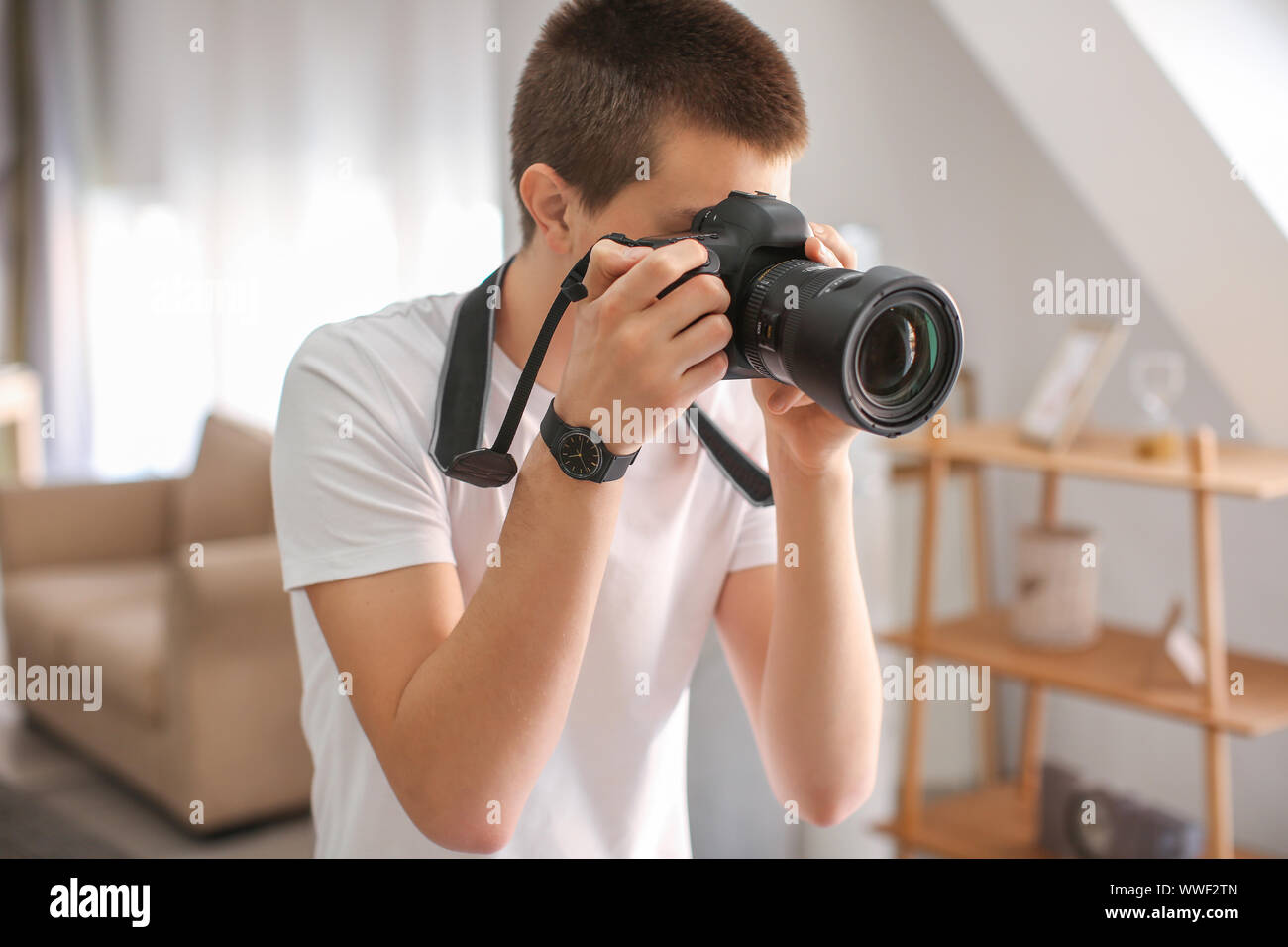 Teenage boy with photo camera at home Stock Photo - Alamy