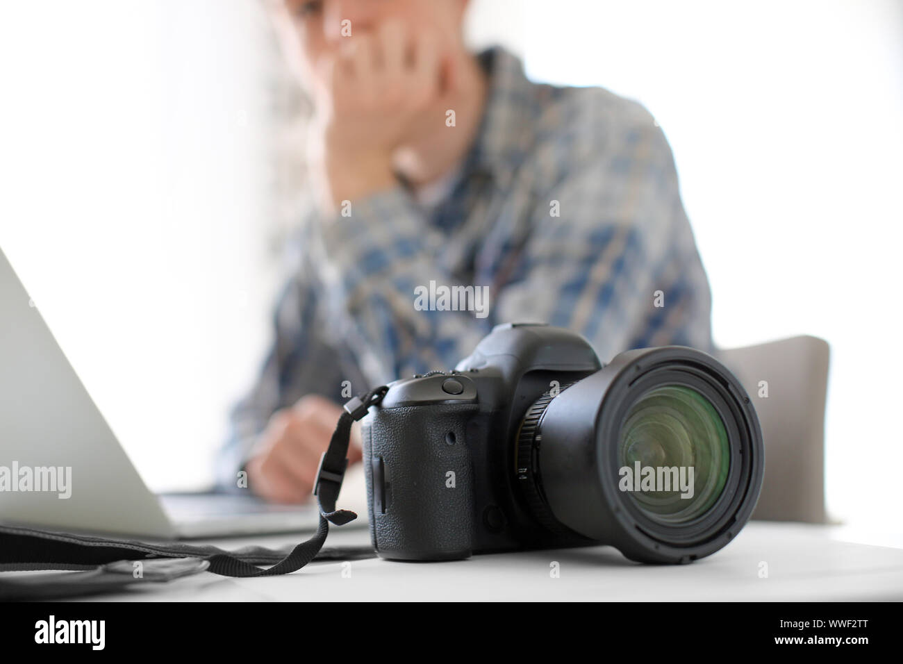 Modern camera on table of photographer Stock Photo - Alamy