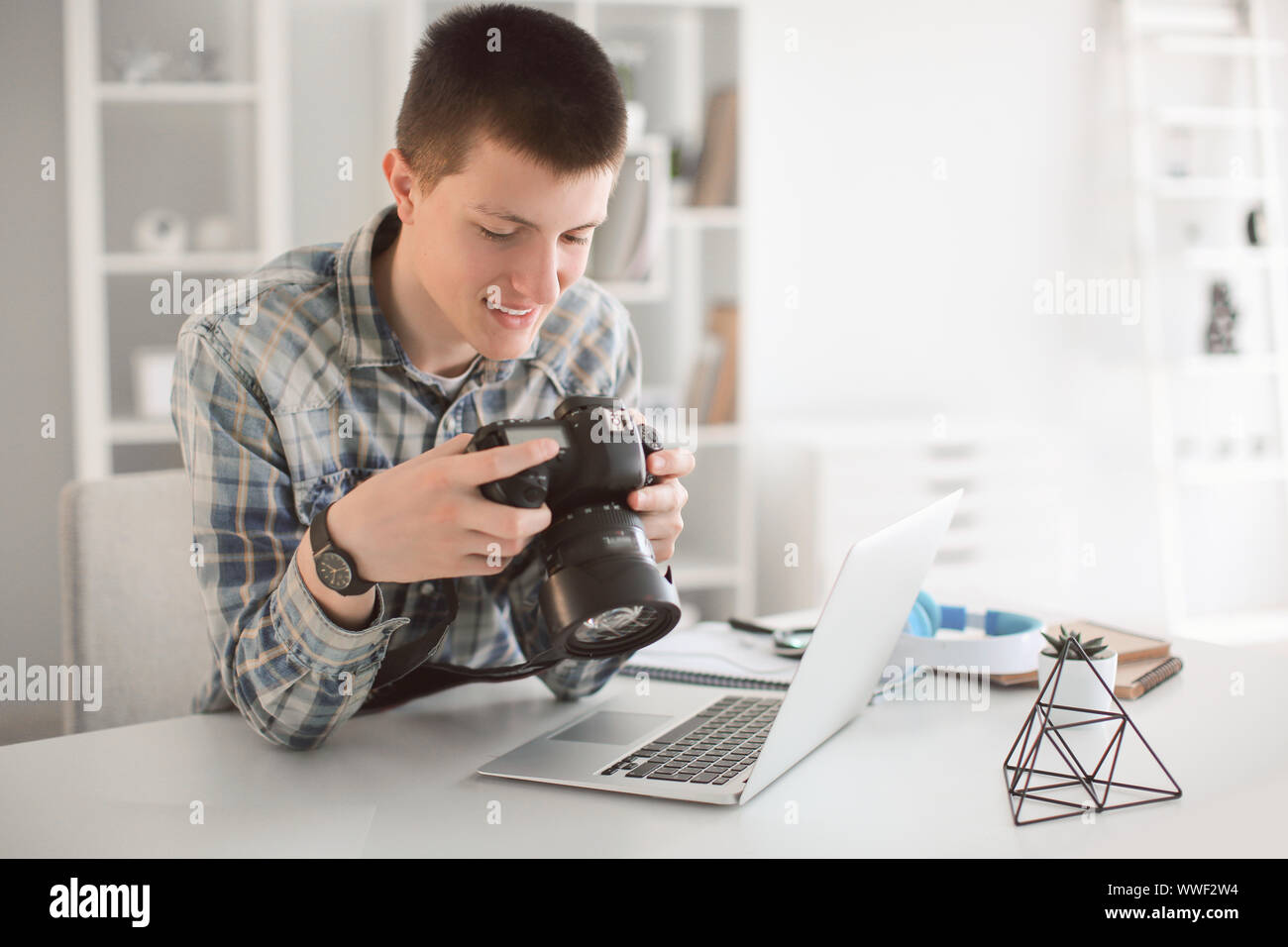 Teenage boy with photo camera at home Stock Photo - Alamy