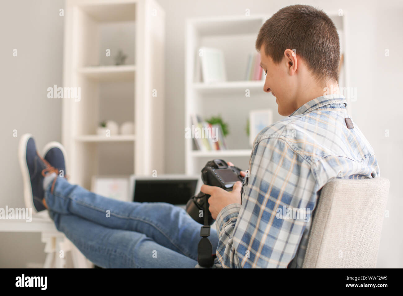 Teenage boy with photo camera at home Stock Photo - Alamy