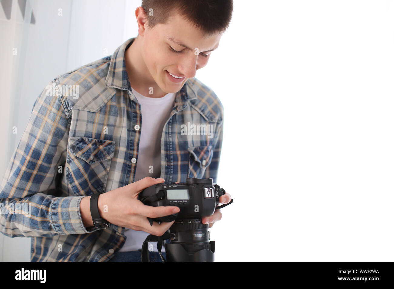 Teenage boy with photo camera at home Stock Photo - Alamy