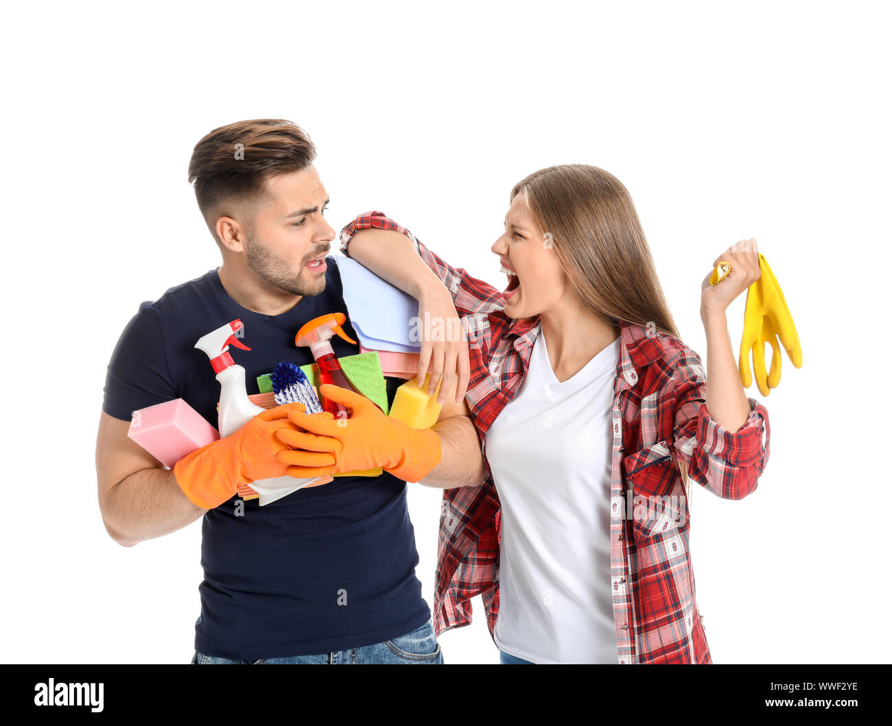 Angry wife scolding her husband with cleaning supplies on white ...