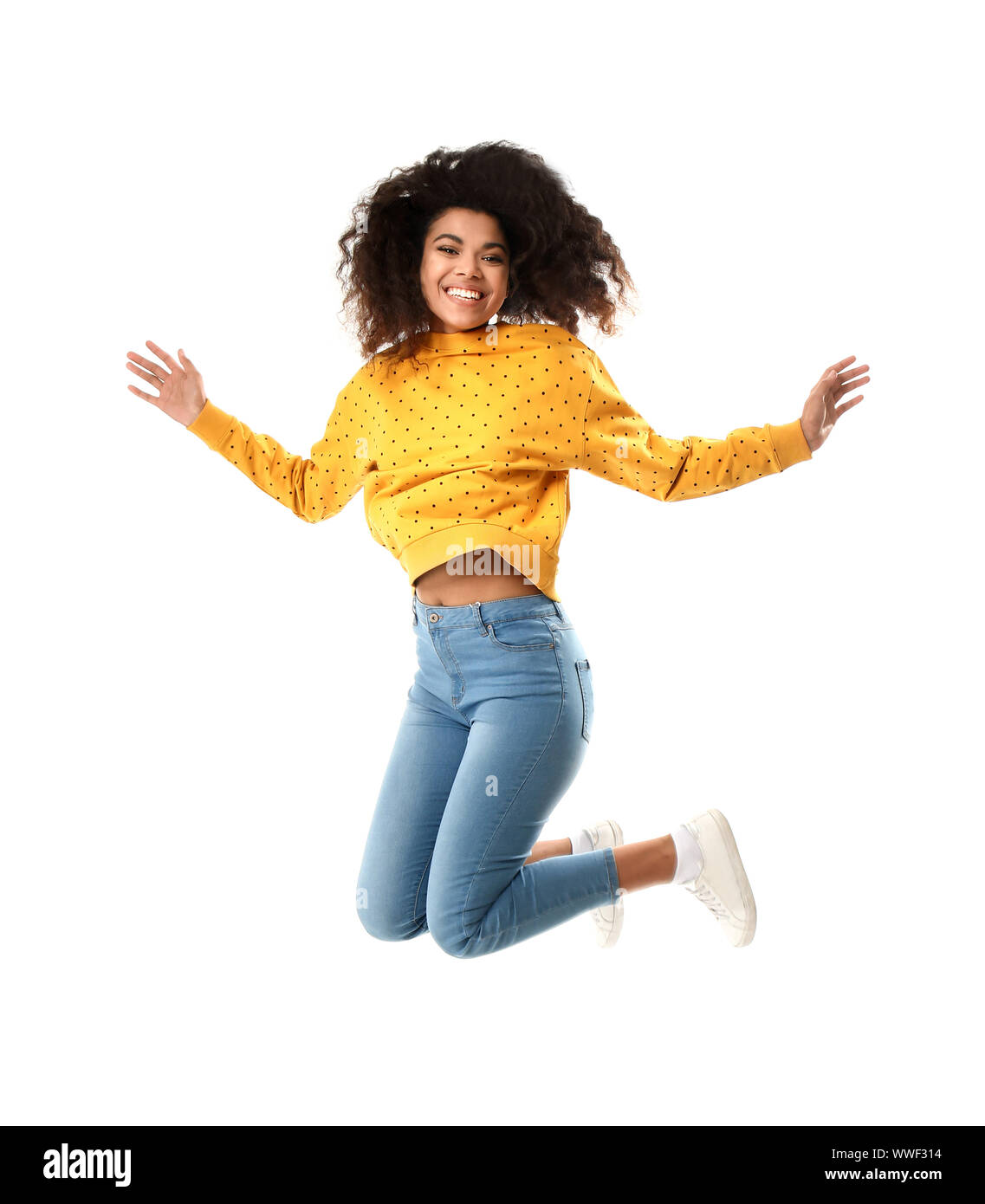 Jumping African-American woman on white background Stock Photo - Alamy