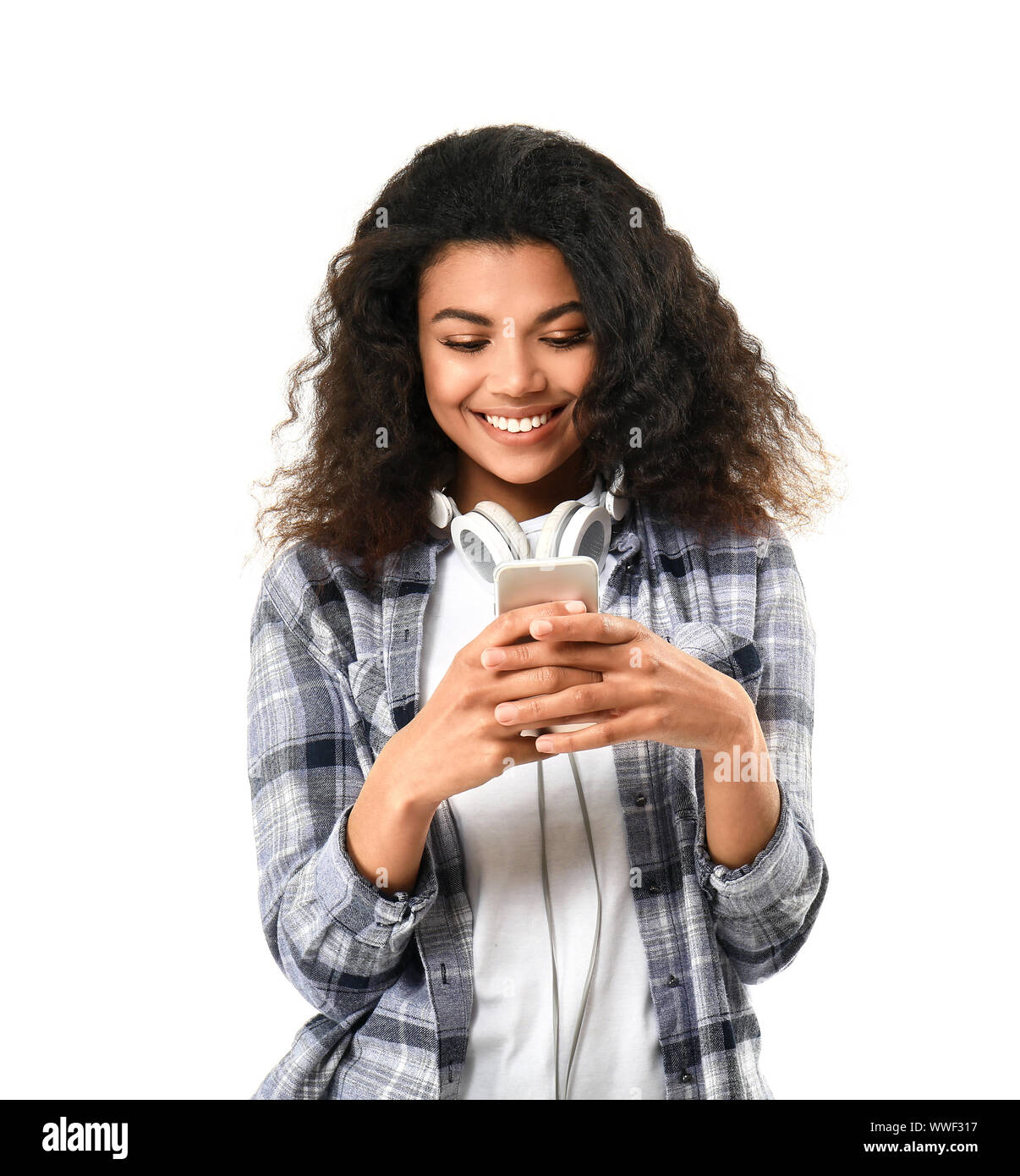 Portrait of cute African-American woman with mobile phone on white ...