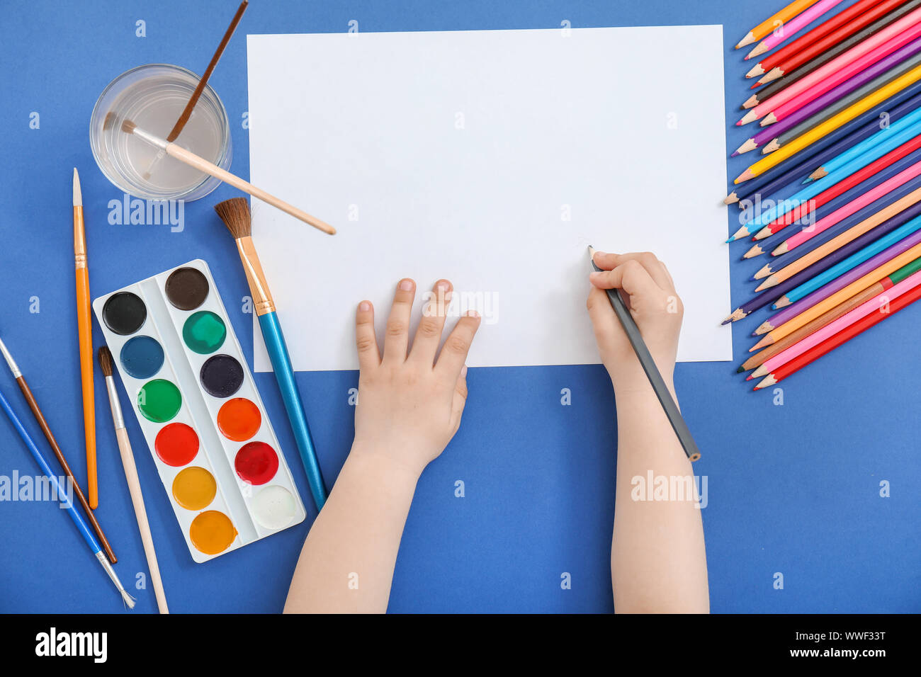 Cute little child drawing at table, top view Stock Photo - Alamy