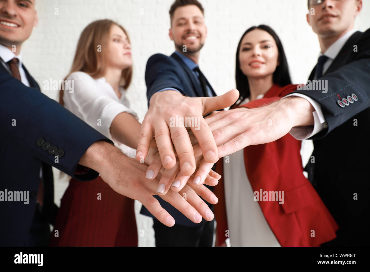 Team of business people putting hands together, closeup Stock Photo - Alamy