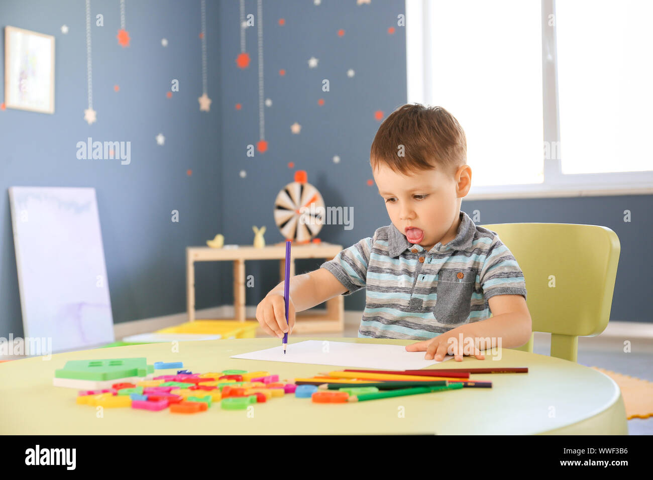 Little boy with autistic disorder in playroom Stock Photo - Alamy