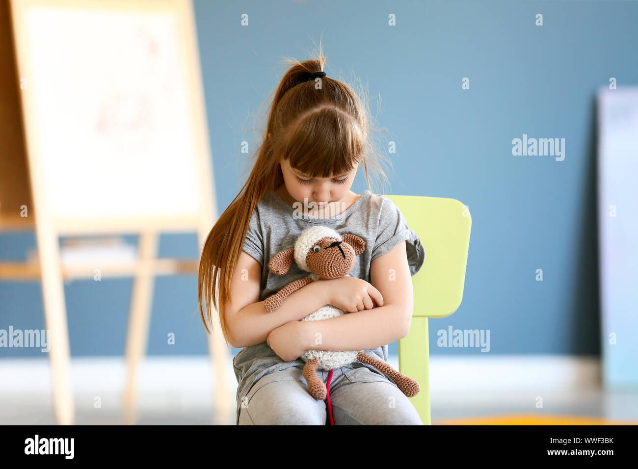 Sad little girl with autistic disorder in playroom Stock Photo - Alamy