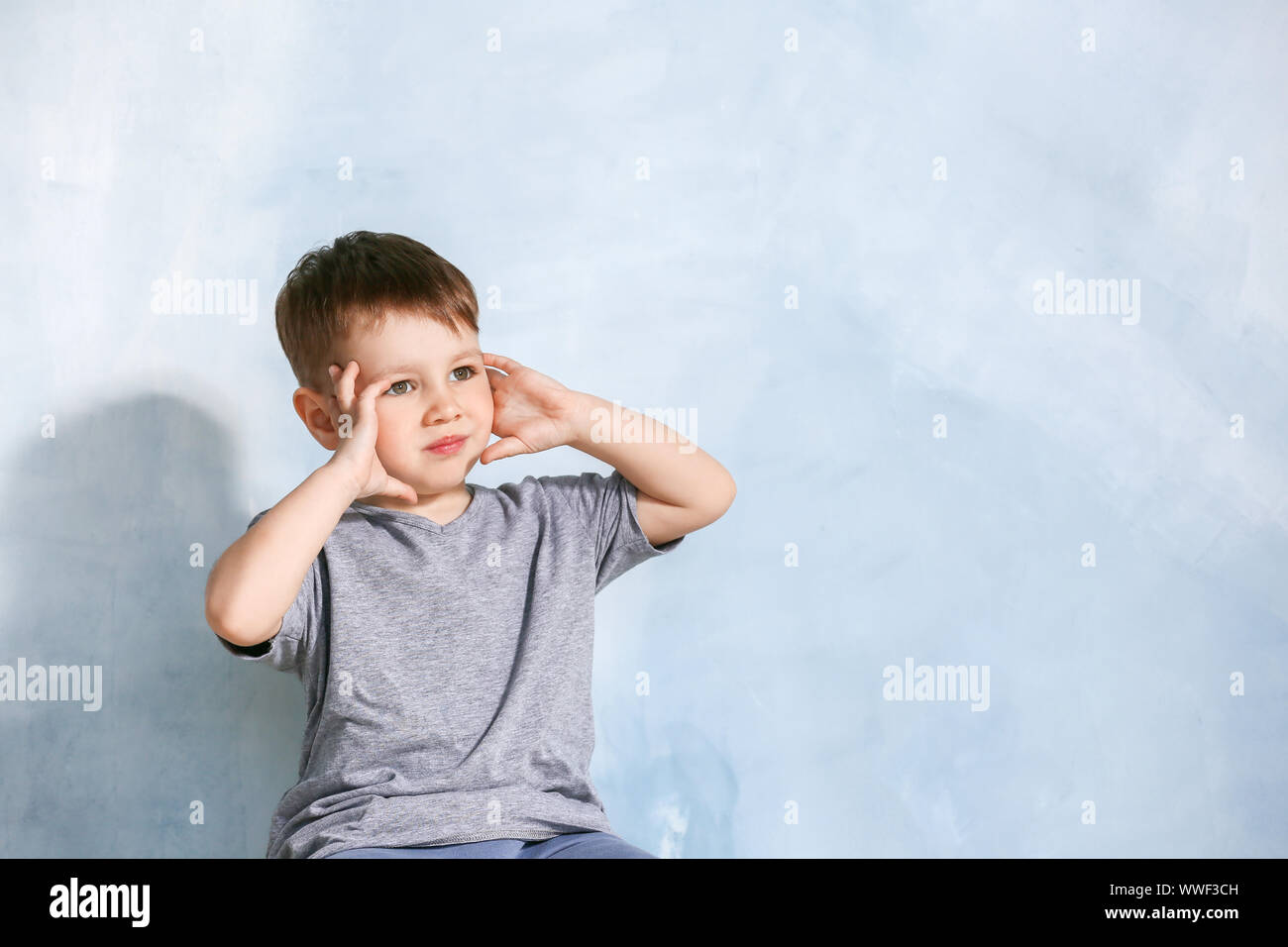 Little boy with autistic disorder on light background Stock Photo - Alamy