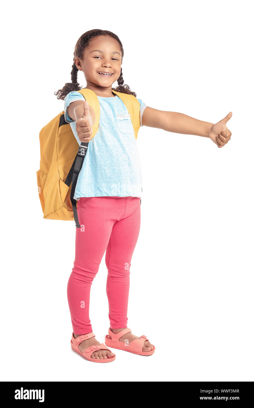 Adorable little African-American schoolgirl showing thumb-up gesture on ...