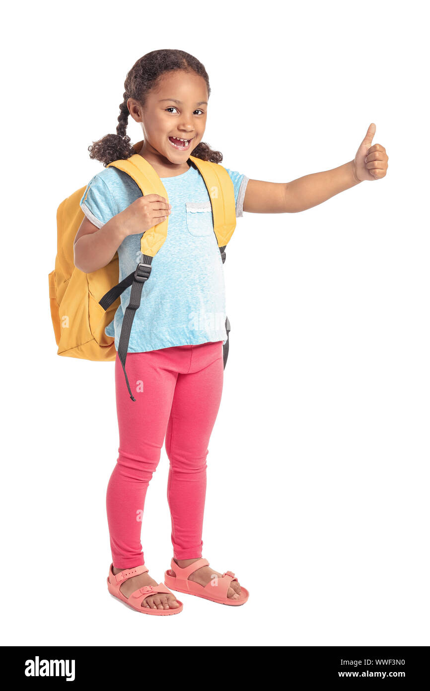 Adorable little African-American schoolgirl showing thumb-up gesture on ...