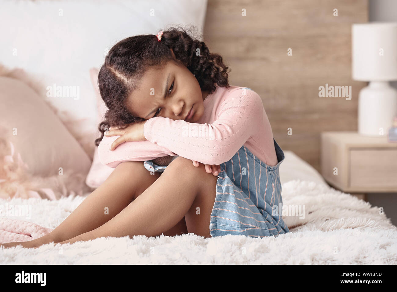 Sad little African-American girl sitting on bed Stock Photo - Alamy Sad little African-American girl sitting on bed Stock Photo - Alamy
