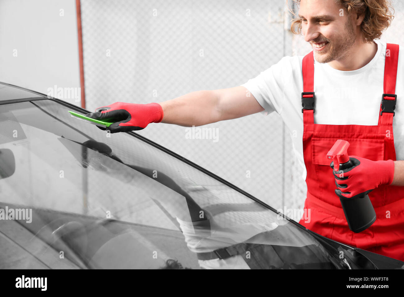 Male worker tinting car window outdoors Stock Photo - Alamy