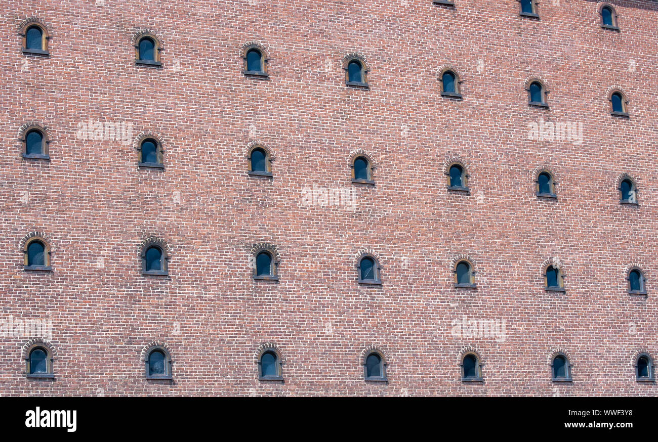 Small windows in former textile mill warehouse Stock Photo - Alamy