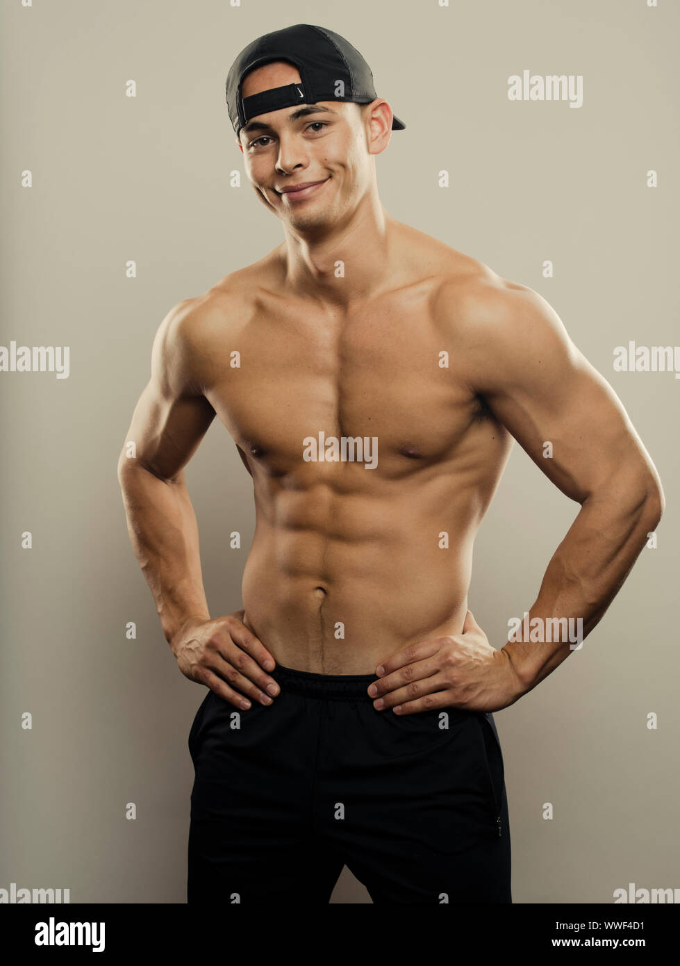 muscular young man wearing cap Stock Photo - Alamy