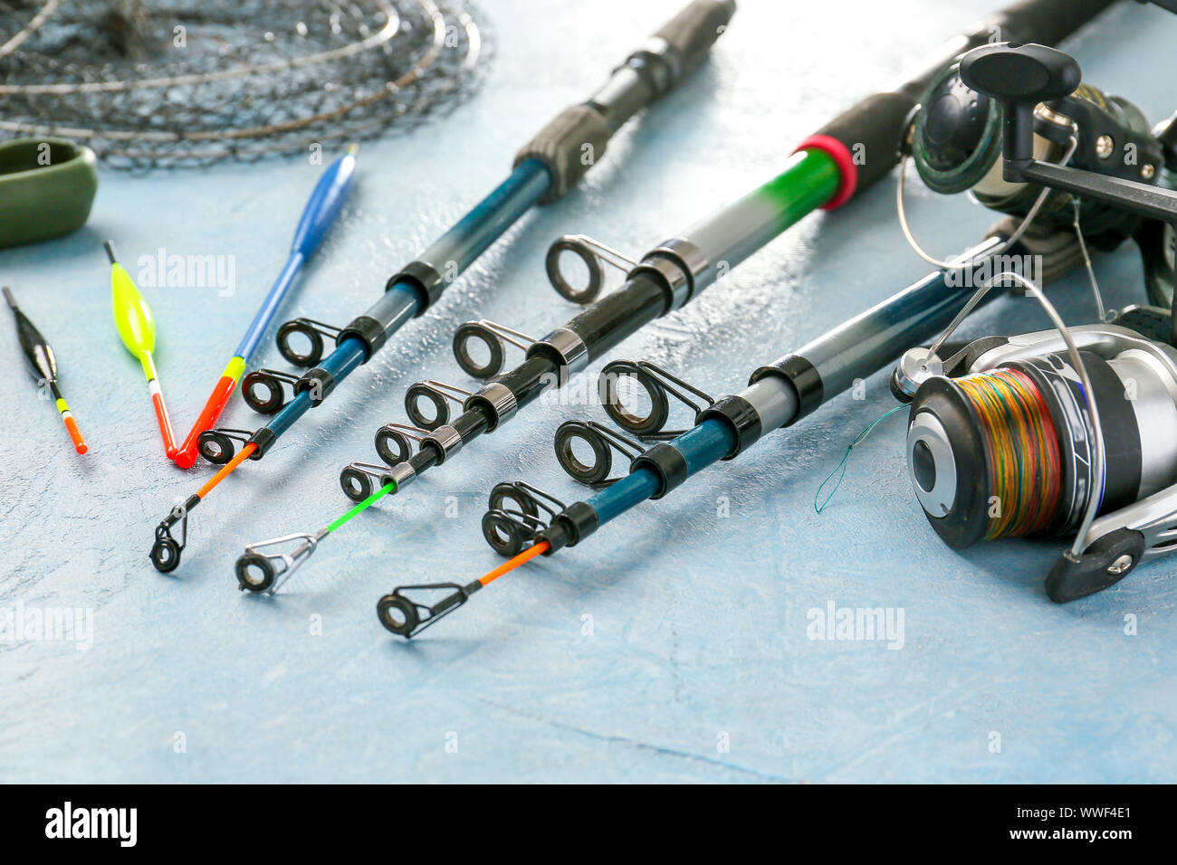 Different fishing equipment on color background Stock Photo - Alamy