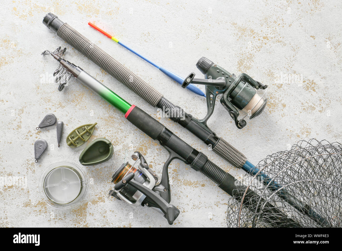 Different fishing equipment on light background Stock Photo - Alamy