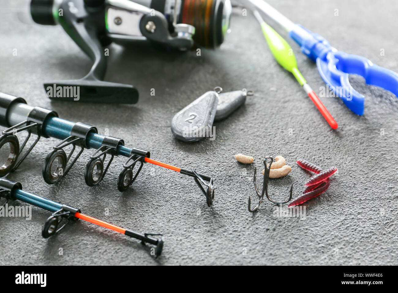 Different fishing equipment on grey background Stock Photo - Alamy