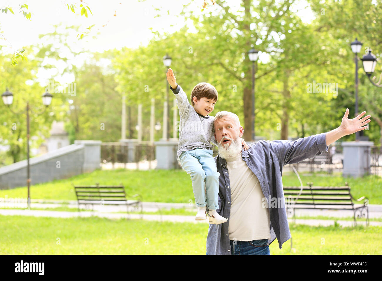 Cute little boy with grandfather in park Stock Photo - Alamy