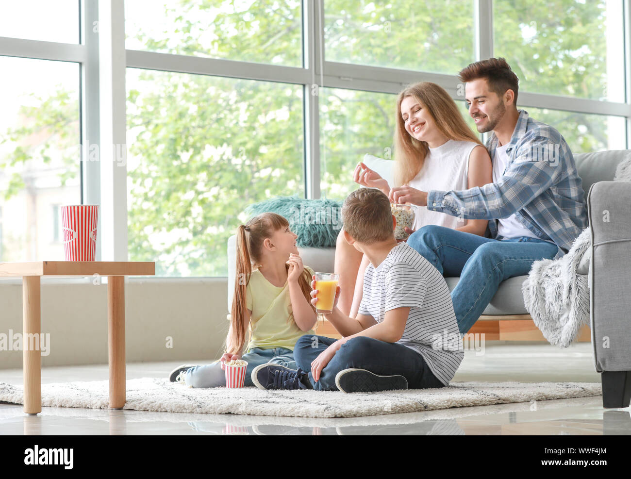 Happy family watching TV at home Stock Photo - Alamy