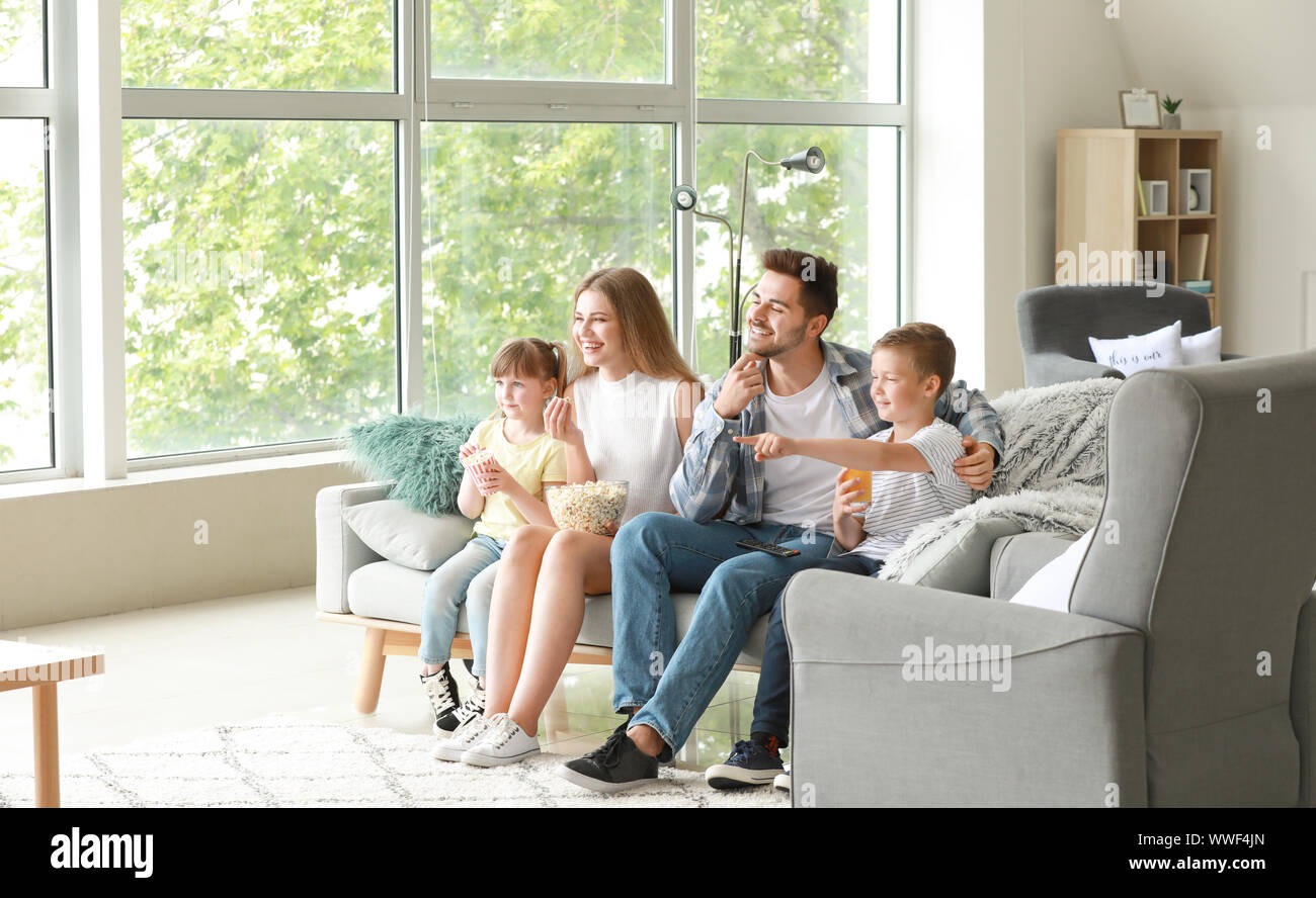 Happy family watching TV at home Stock Photo - Alamy