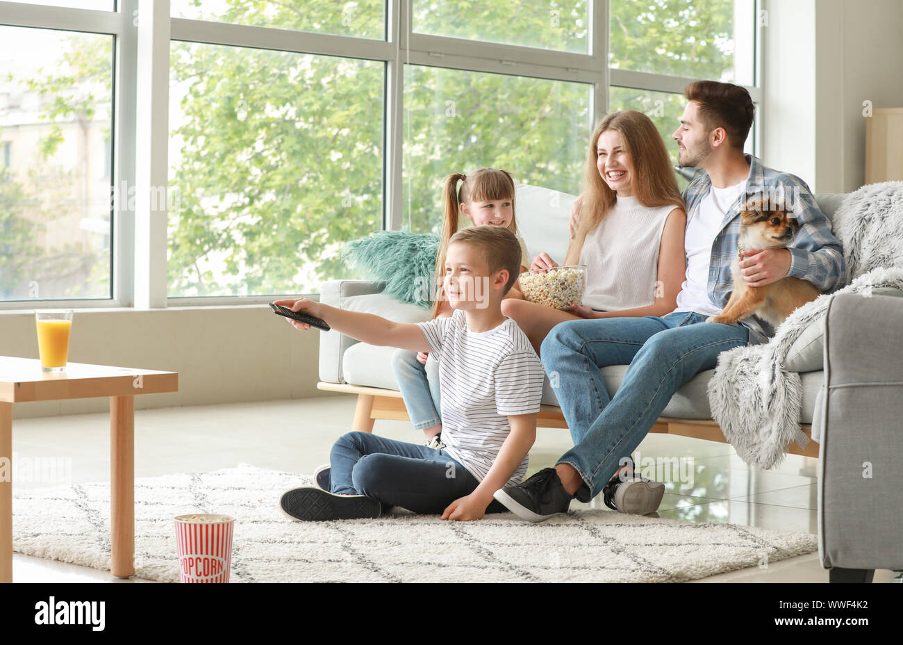 Happy family watching TV at home Stock Photo - Alamy